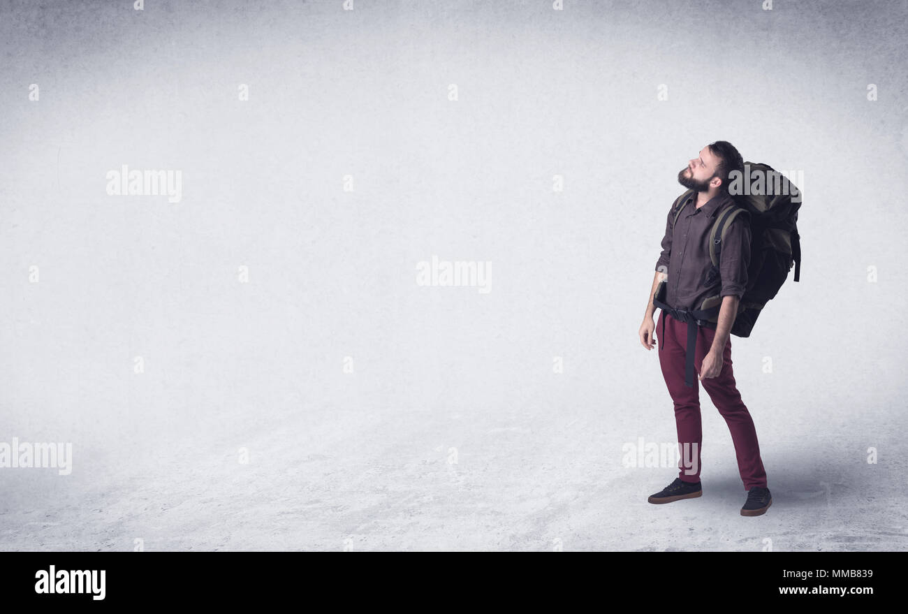 Standing handsome young man with a backpack Stock Photo - Alamy