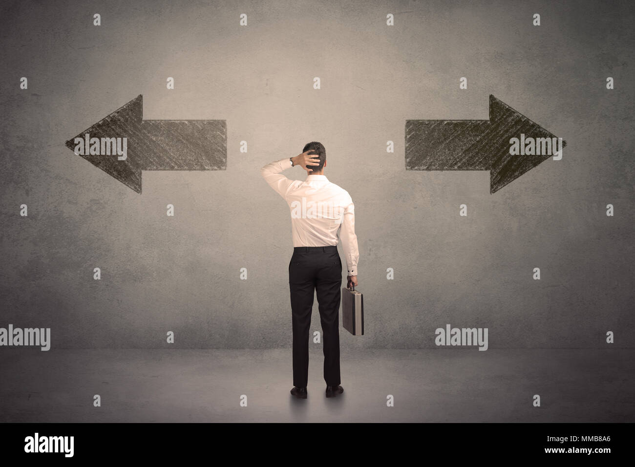 Business man taking a decision while standing in front of two grungy ...