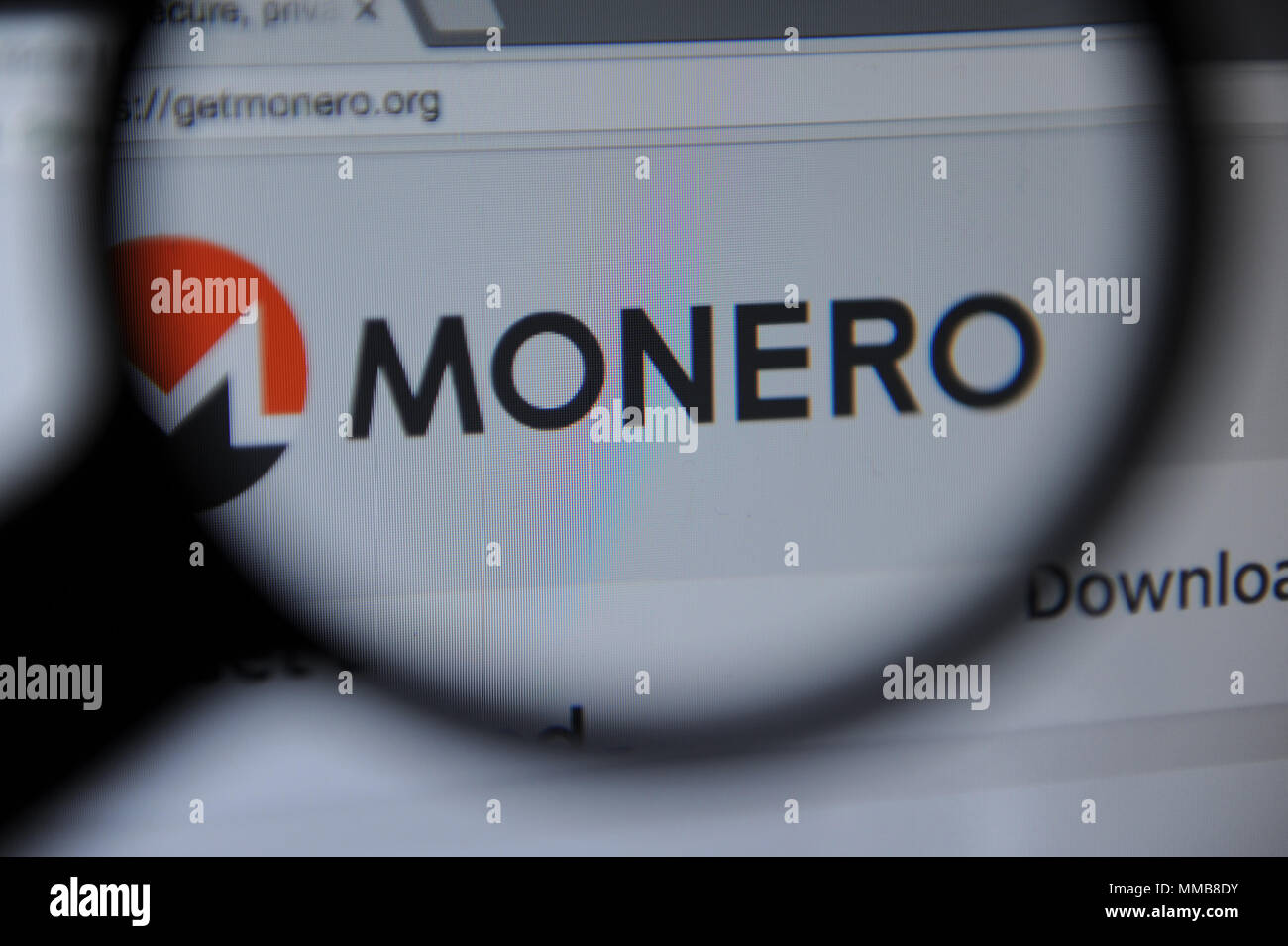 Monero cryptocurrency website seen through a magnifying glass Stock ...