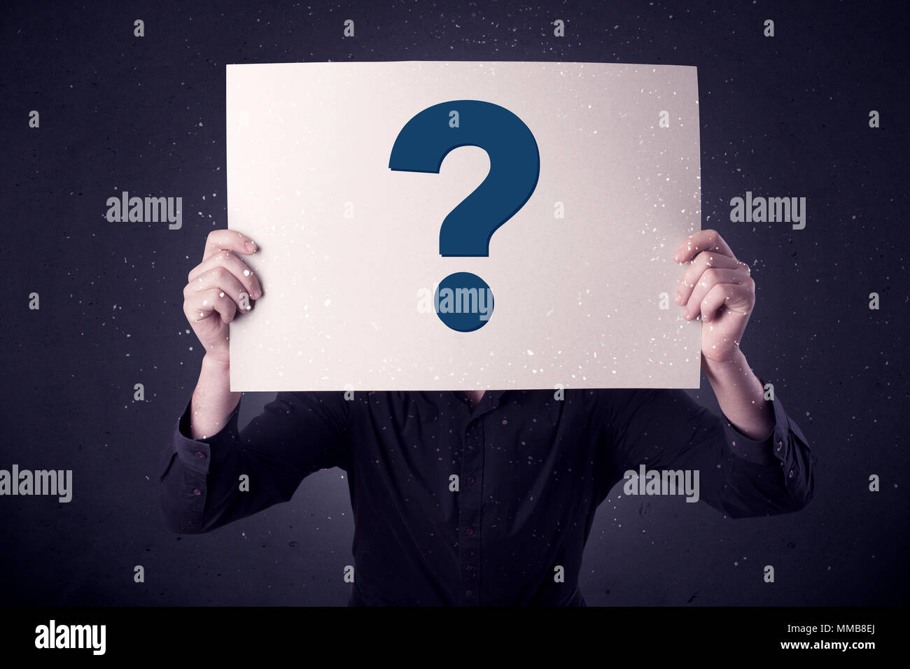 Young businessman hiding behind a question mark drawn on paper Stock ...