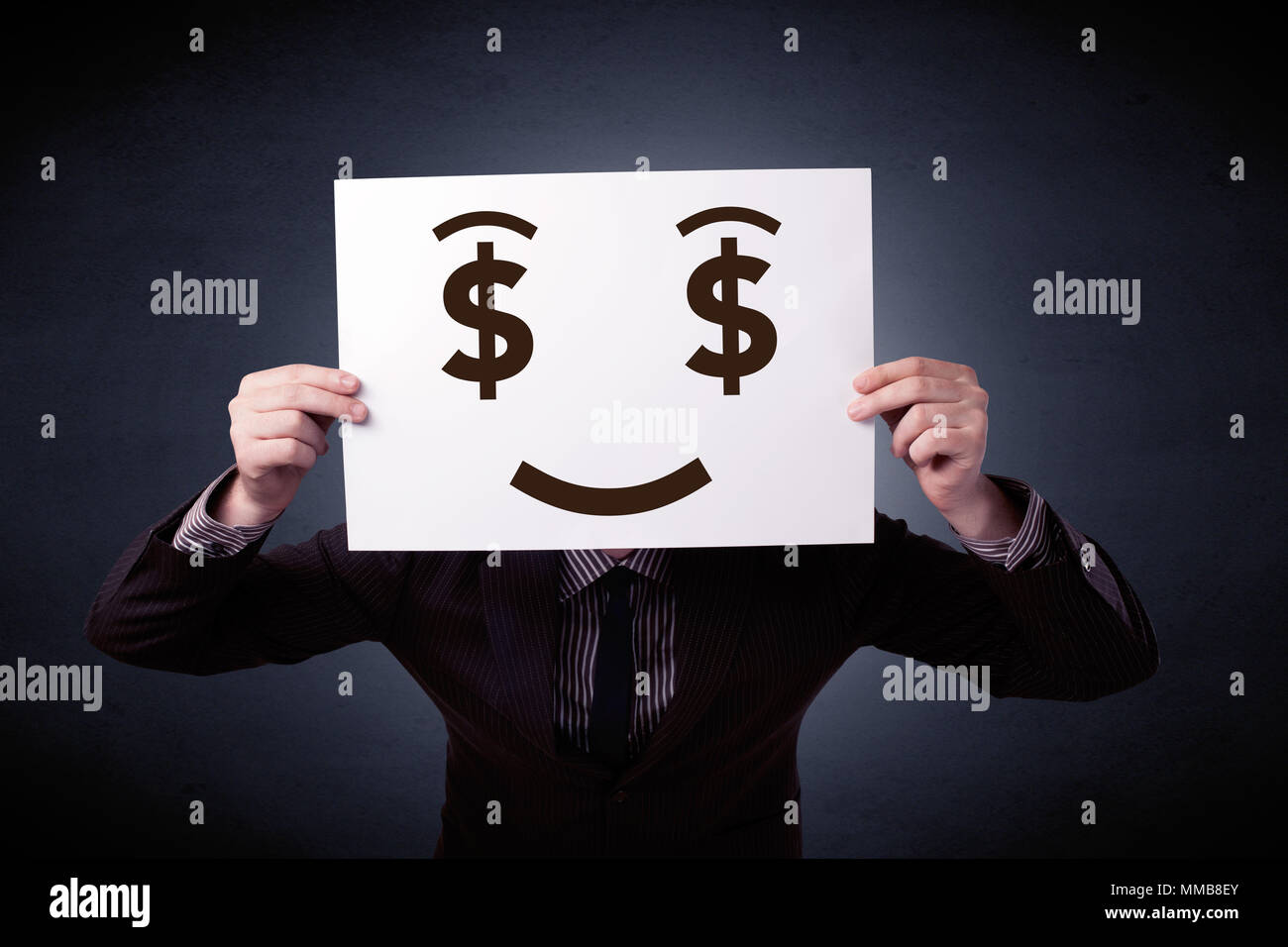 Young casual businessman hiding behind a greedy face drawing on ...