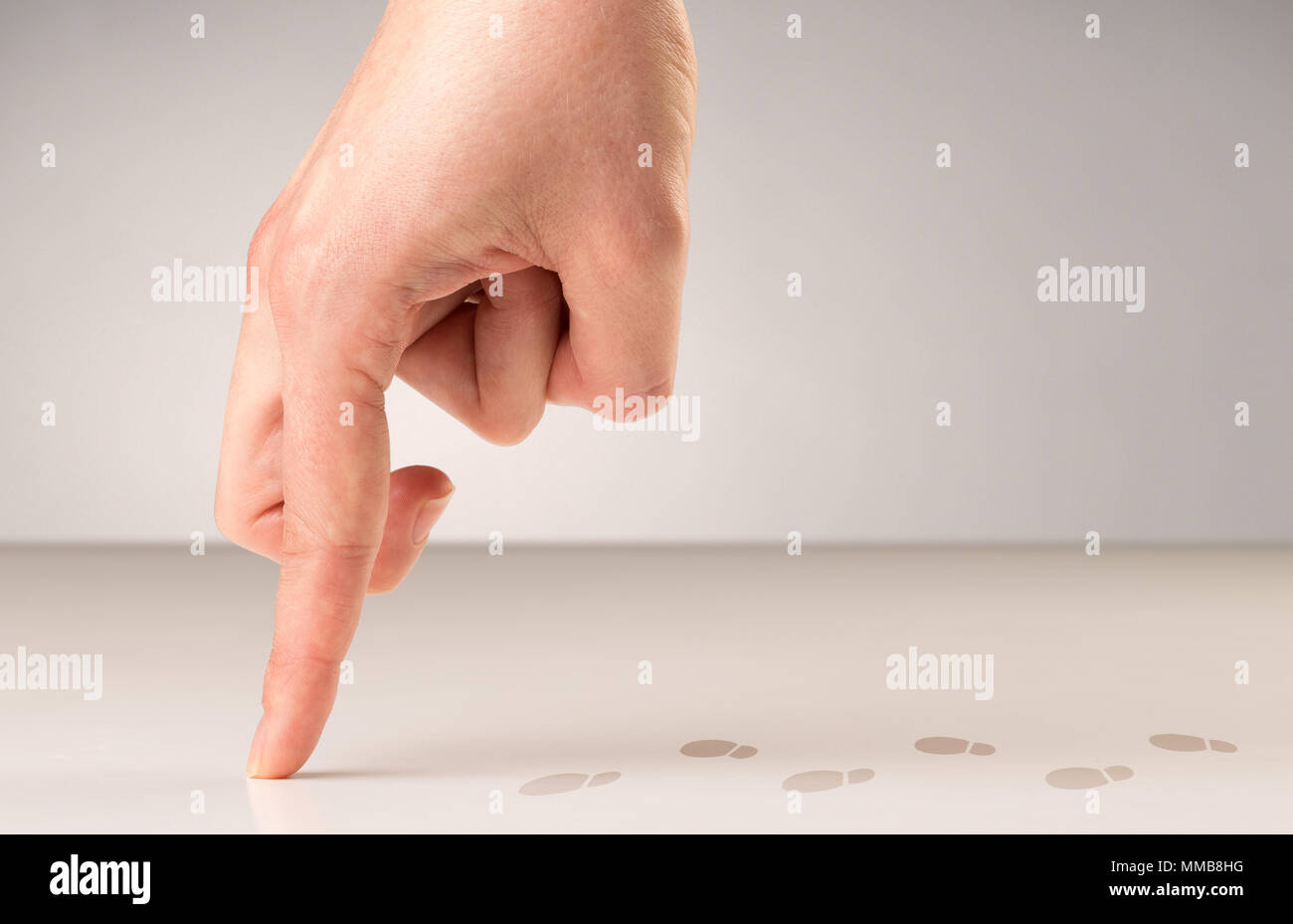 Female fingers walking on white surface with footsteps behind it Stock ...