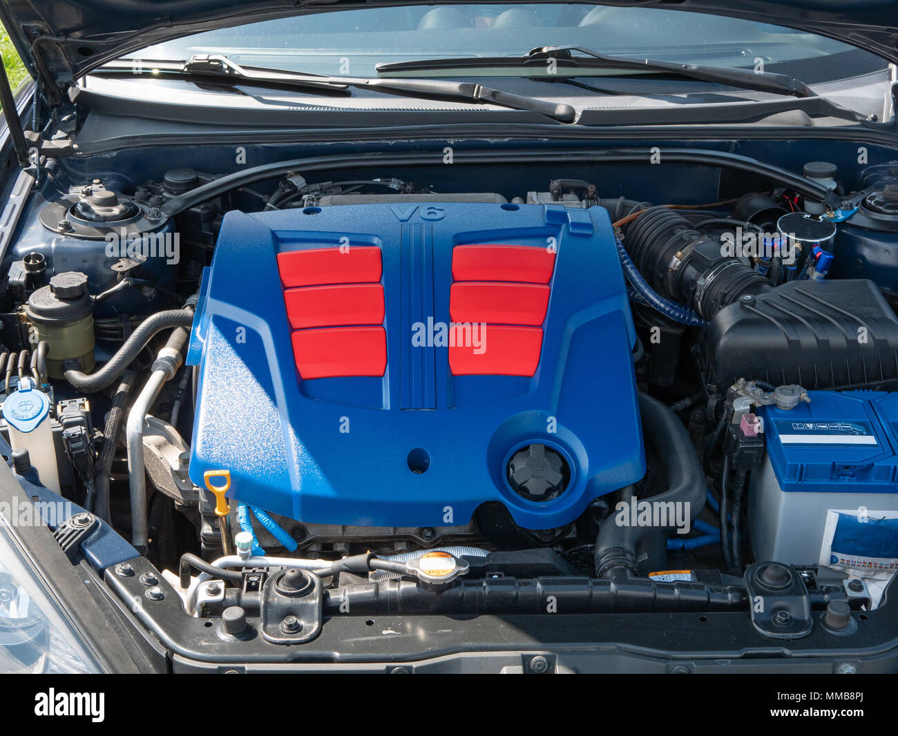 opened car hood vehicle compartment with engine covered by shiny ...