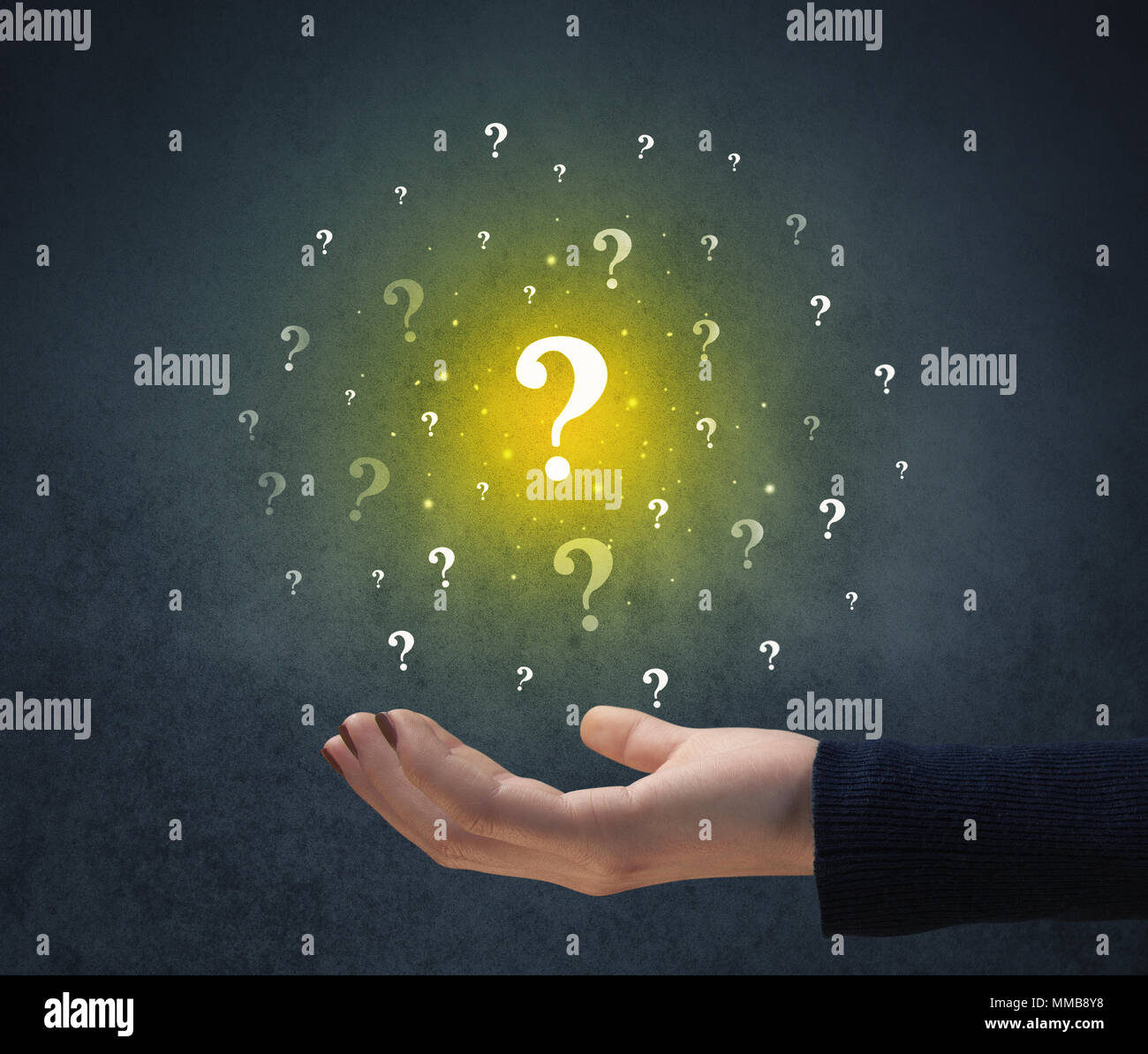 Yellow question marks hovering over young hand Stock Photo - Alamy