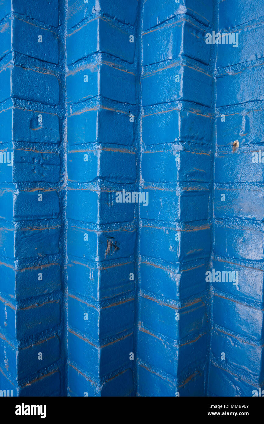 A bright blue brick wall with an interesting pattern Stock Photo - Alamy