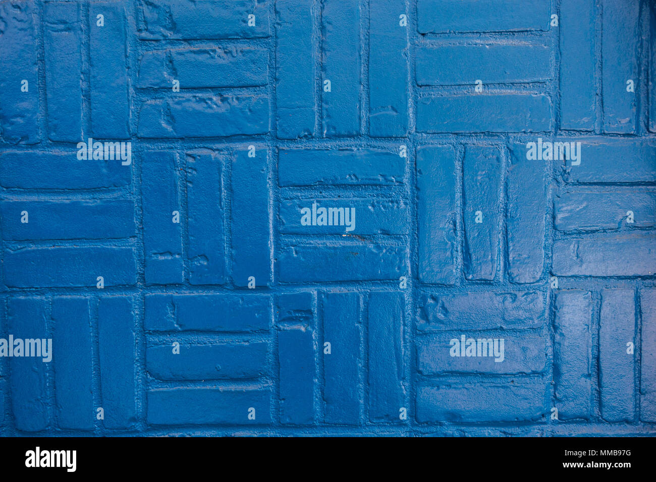 A bright blue brick wall with an interesting pattern Stock Photo - Alamy