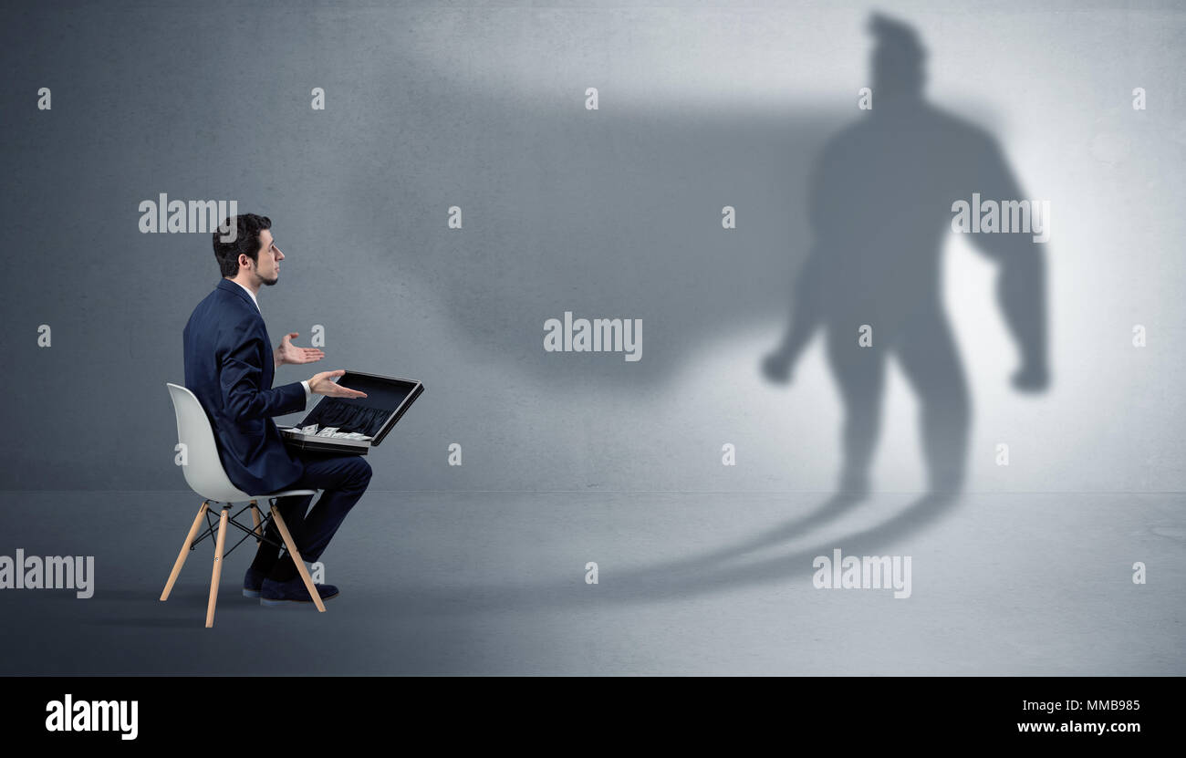 Humble businessman staying and offering stuffs to a superhero shadow ...