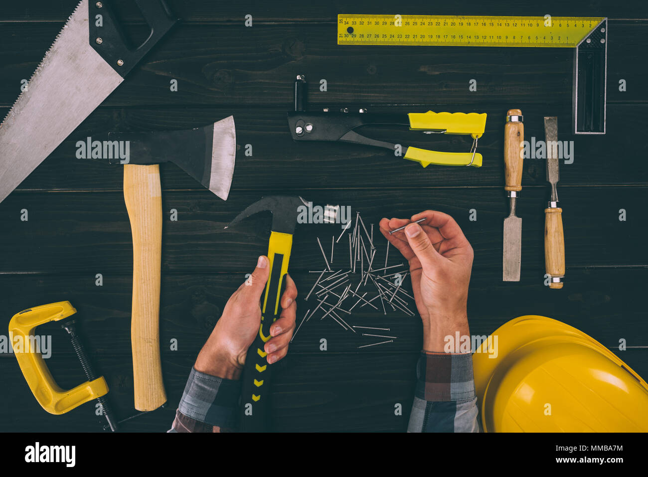 partial view of carpenter holding industrial tools in hands Stock Photo ...