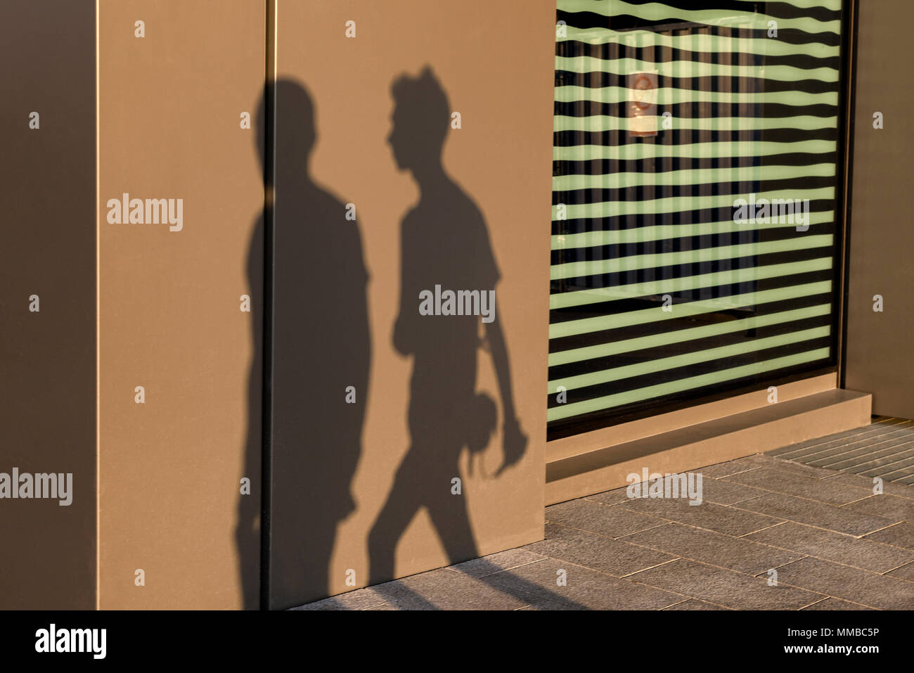 Shadows of two men on the wall Stock Photo - Alamy