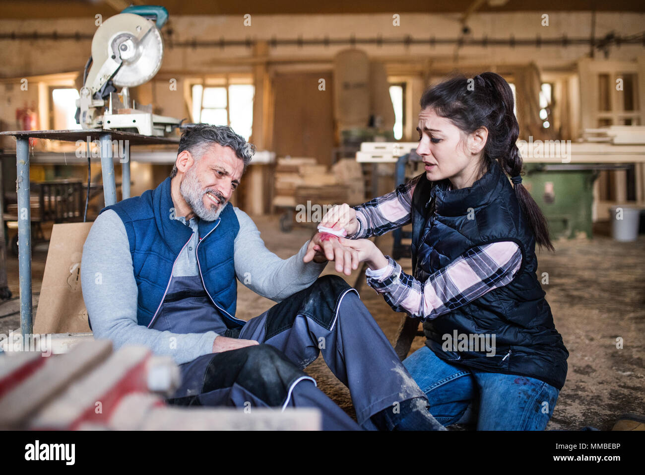 Man and woman workers after an accident in the carpentry workshop Stock ...