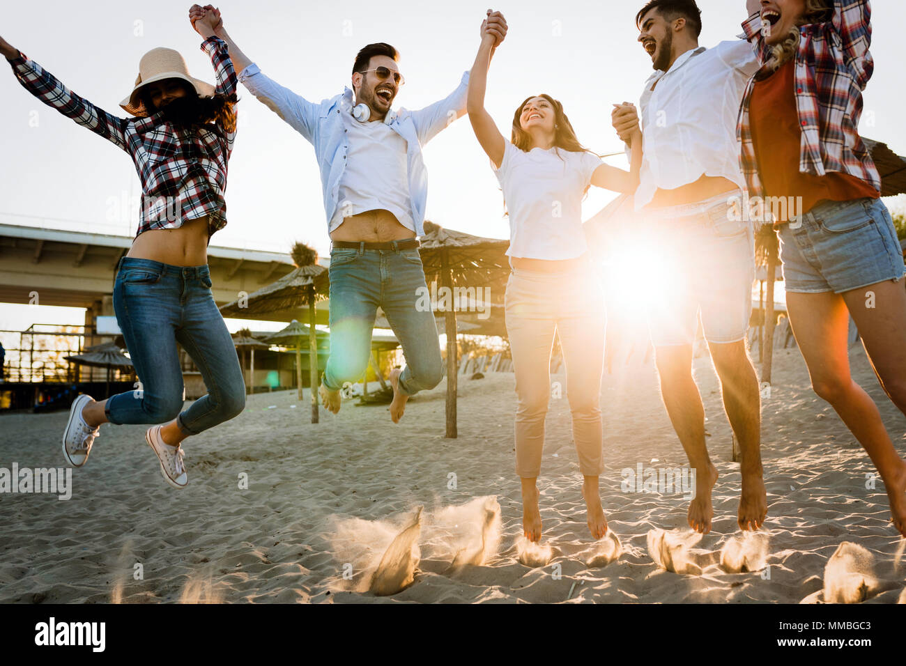 Group of happy friends partying on beach Stock Photo - Alamy