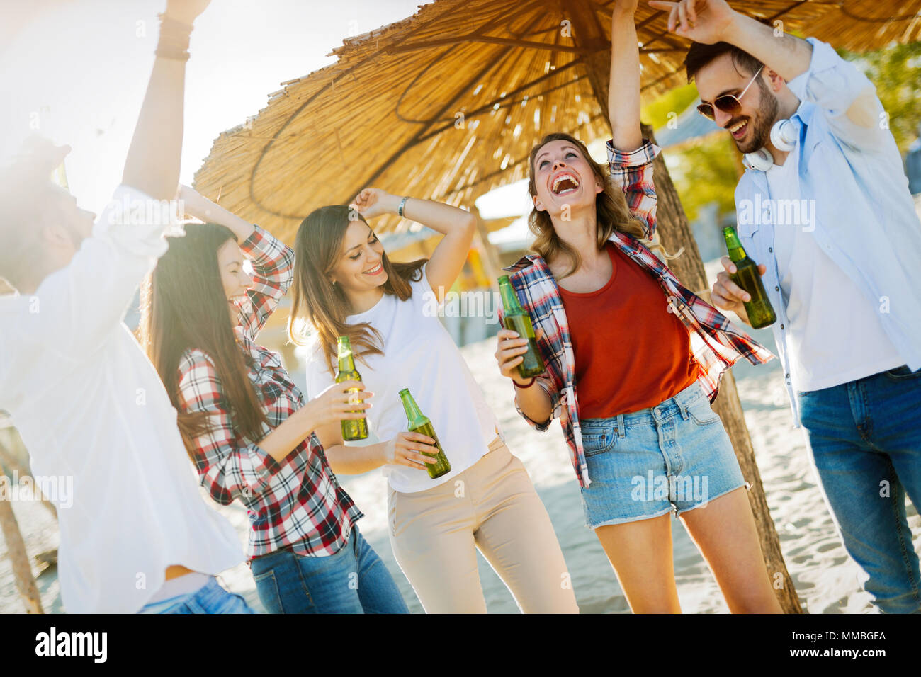 Beach party with friends. Cheerful young people spending nice time ...