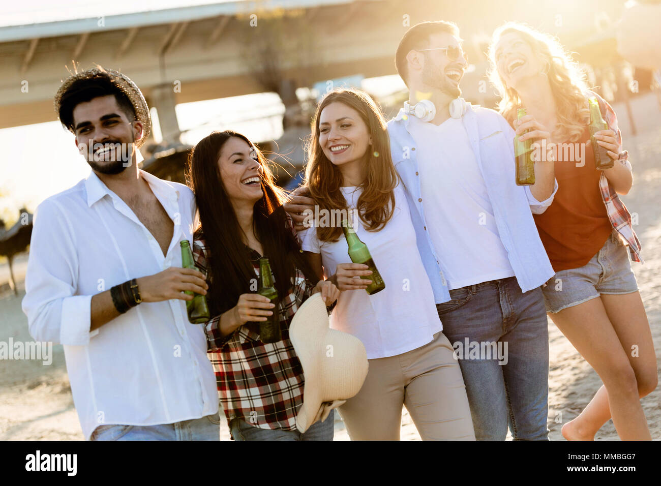 Group of happy friends partying on beach Stock Photo - Alamy
