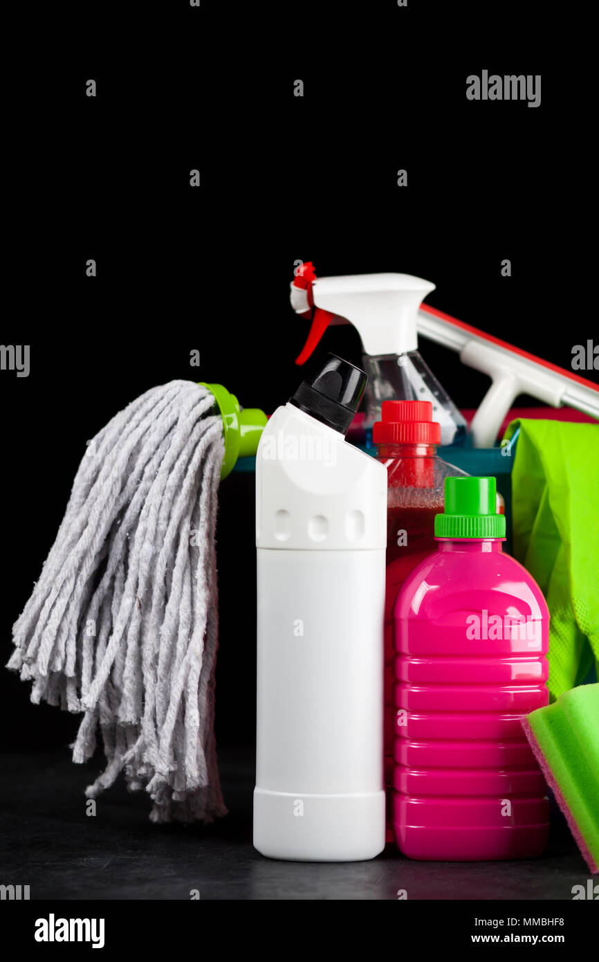 Cleaning supplies on black background Stock Photo - Alamy