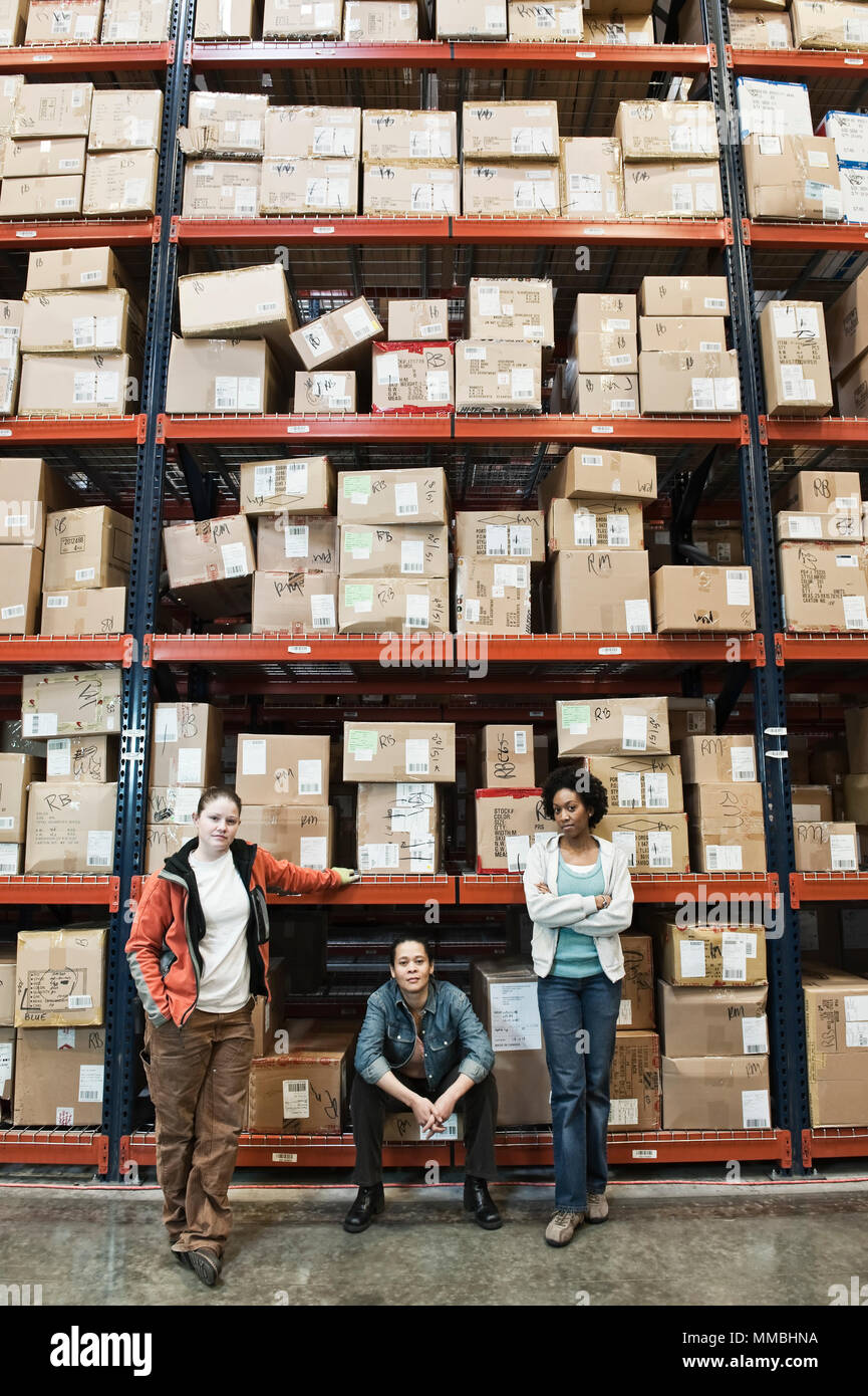 Team portrait of multi-ethnic female warehouse workers in a large ...