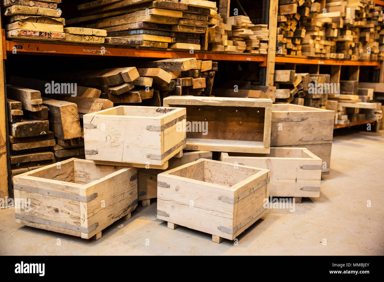 Shelves with wooden planks and a stack of wooden crates in a warehouse ...