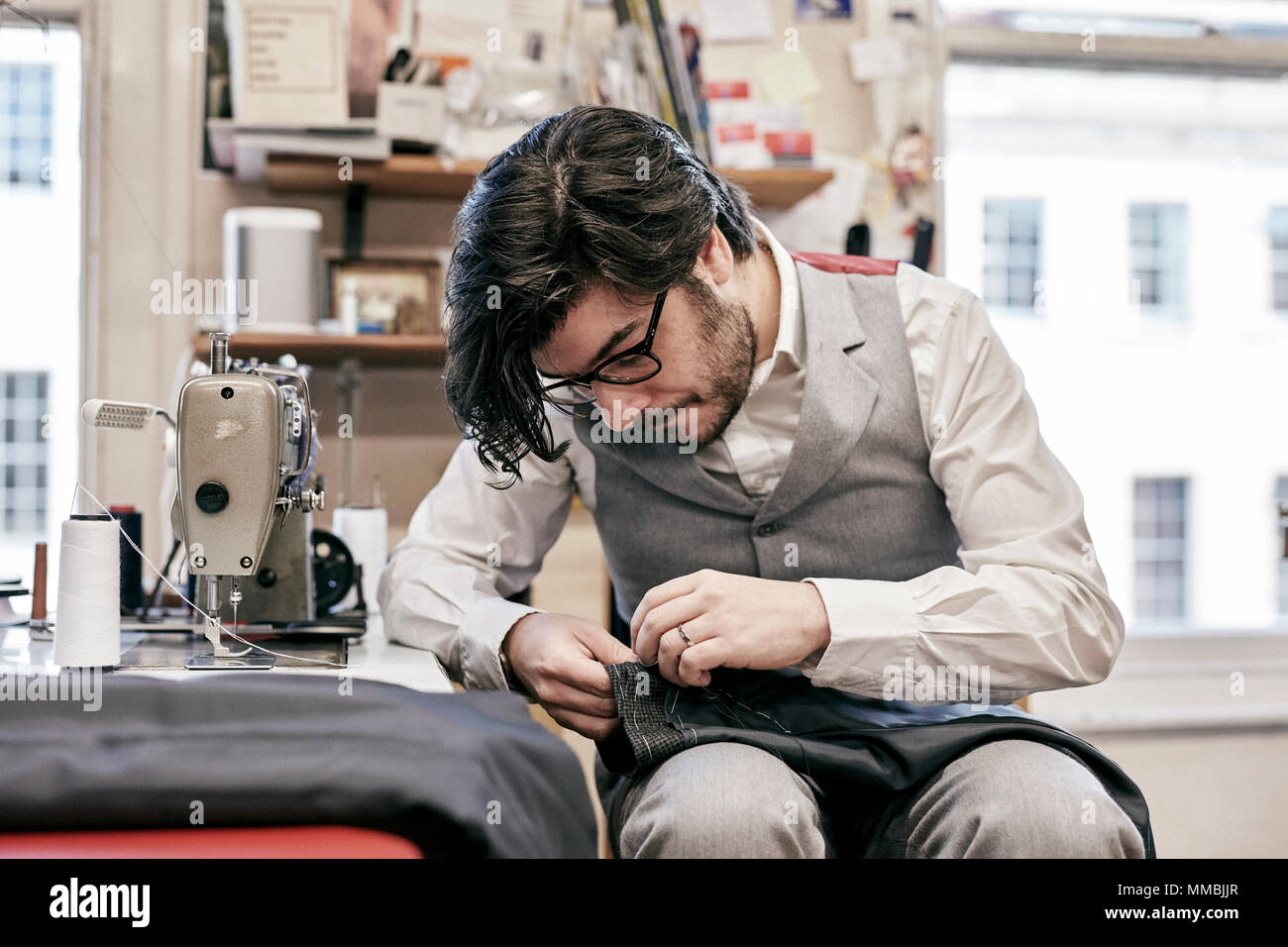 Man sewing hi-res stock photography and images - Alamy