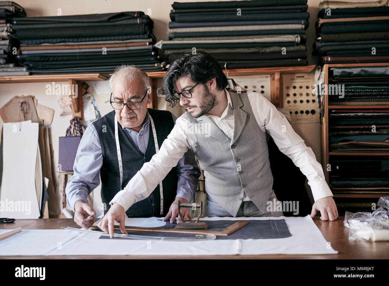 A tailor and a younger man, an assistant or apprentice working together ...