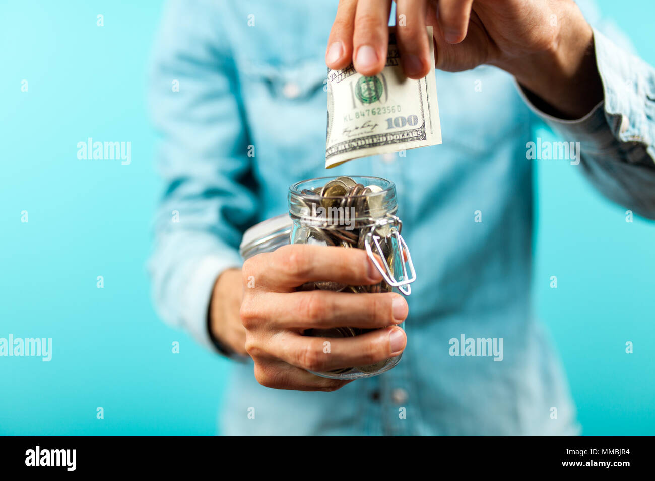 Holding dollar bill and coins hi-res stock photography and images - Alamy