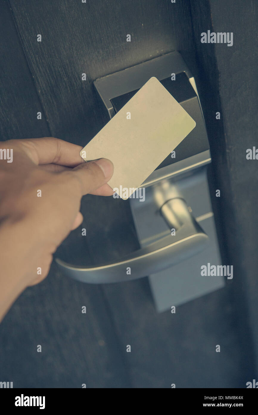Hand holding keycard hotel front electronic sensor of room door Stock ...