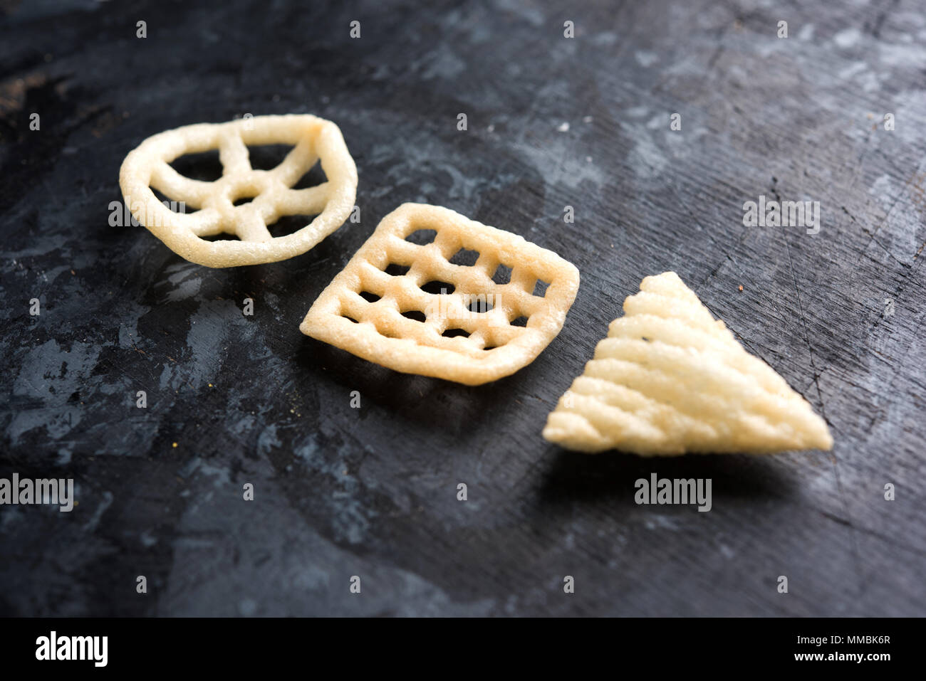 Indian crunchy fryums or papad snack in wheel, square and triangle ...