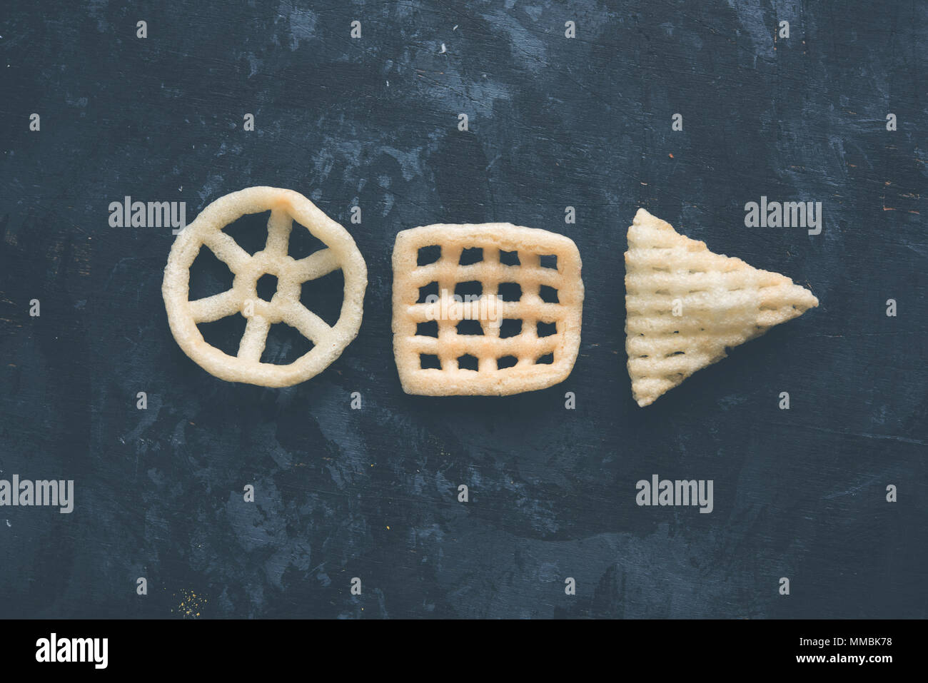 Indian crunchy fryums or papad snack in wheel, square and triangle ...