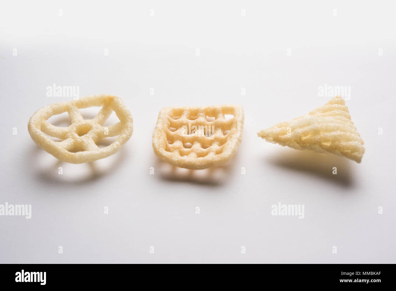 Indian crunchy fryums or papad snack in wheel, square and triangle ...