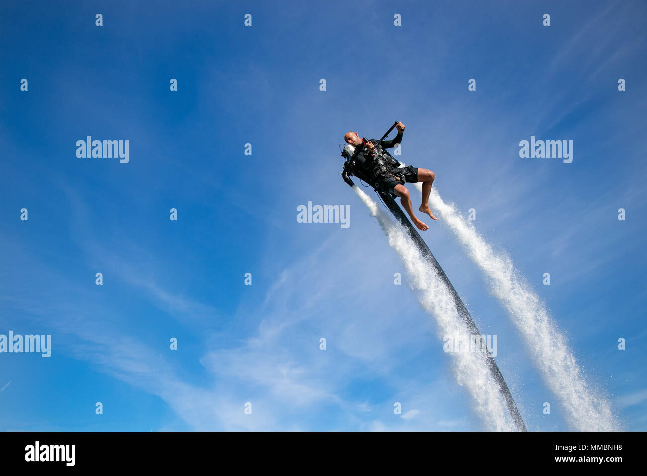 Male thrillseeker athlete levitates on water sport jet levitation ride ...