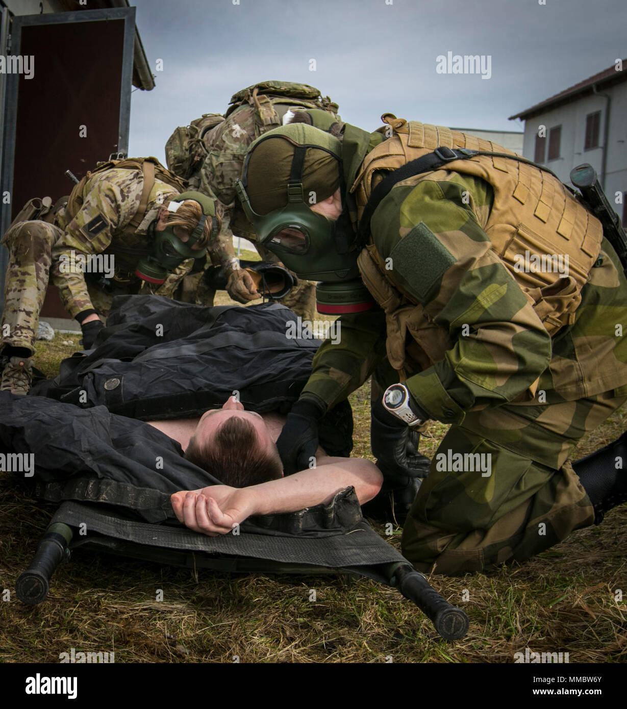 Norwegian and British special operations medics secure a casualty to a ...
