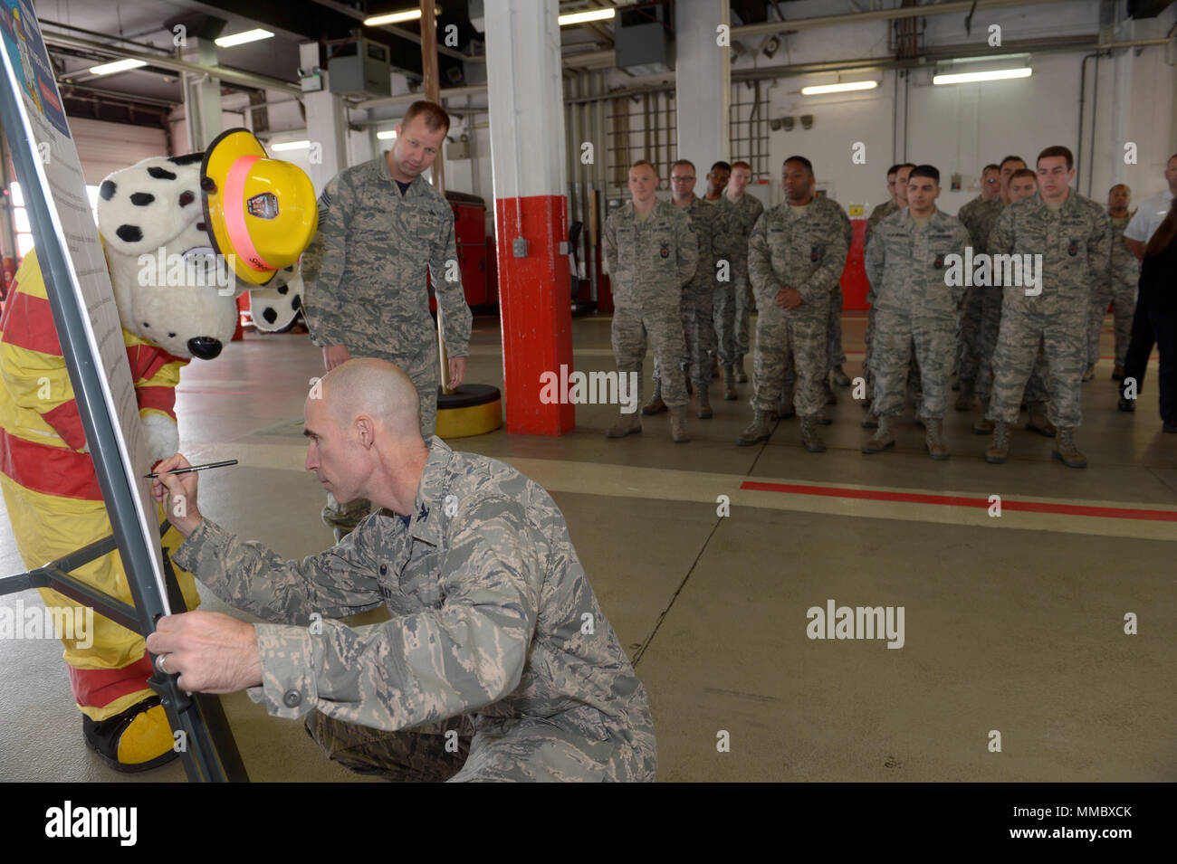 U.S. Air Force Col. Jason Bailey, 52nd Fighter Wing commander, signs ...