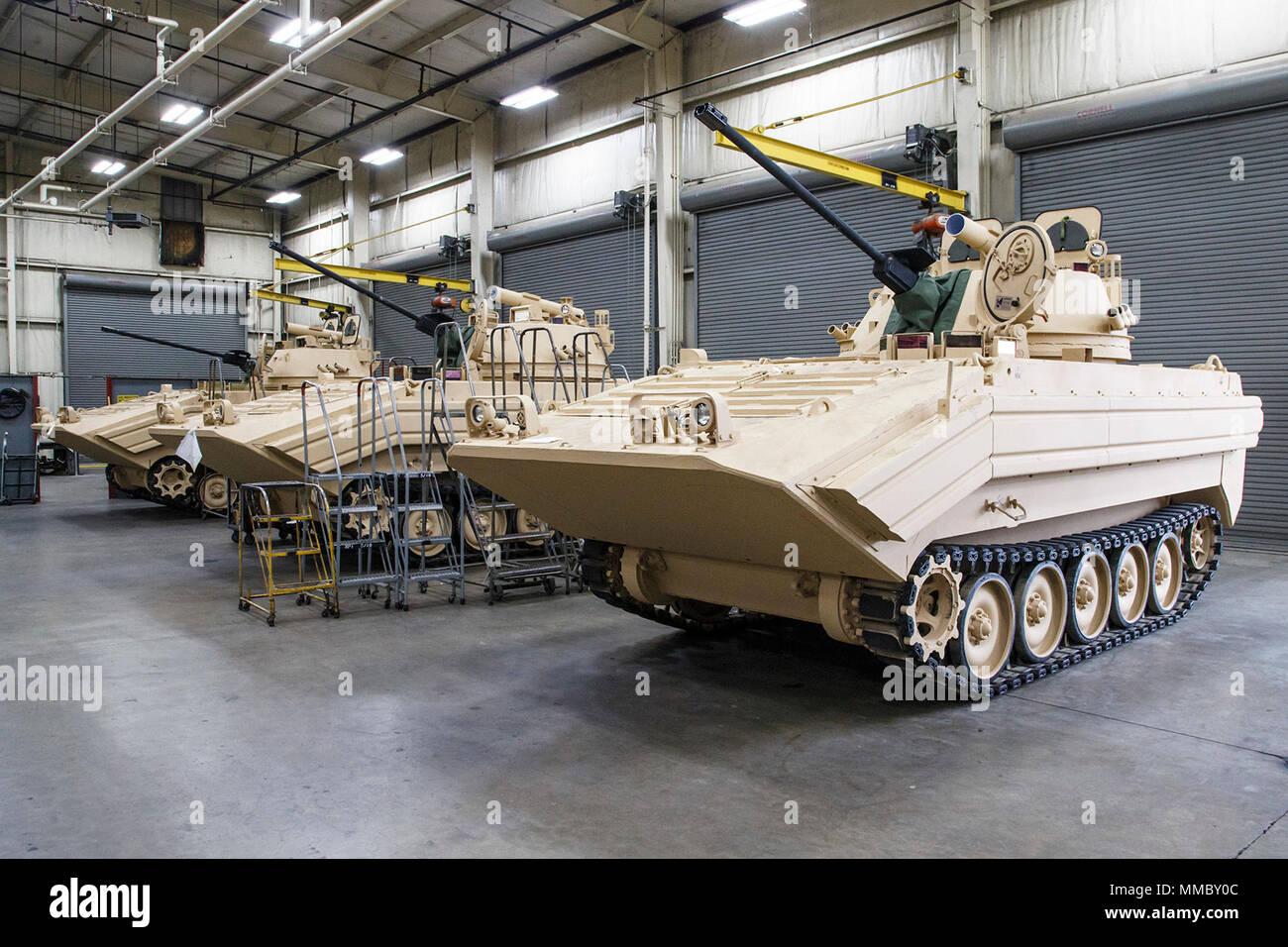 A line of M113A3/BMP-2 Opposing Forces Surrogate Vehicles stand ready ...
