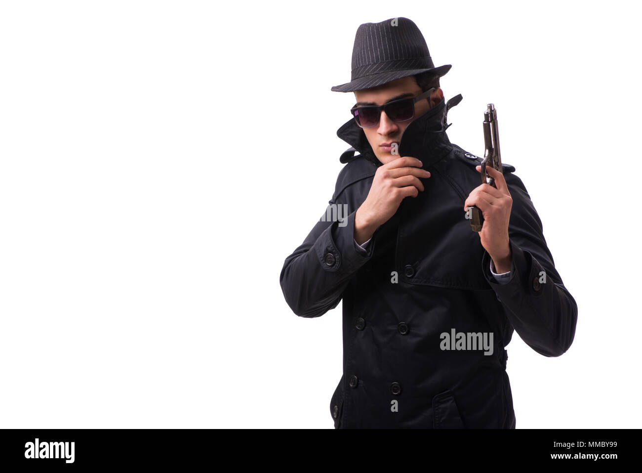 Man spy with handgun isolated on white background Stock Photo - Alamy