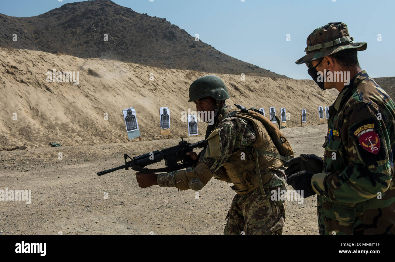 An Afghan Commando instructor gives his trainee directions during a ...