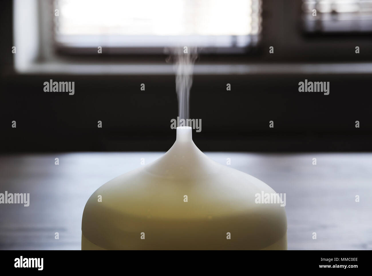 Ultrasonic aroma diffuser. The cold steam is flowing up from the aroma ...