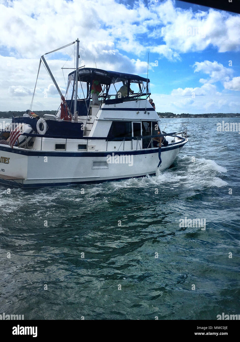 Coast Guard Petty Officer 3rd Class Michael Ford confers with the ...