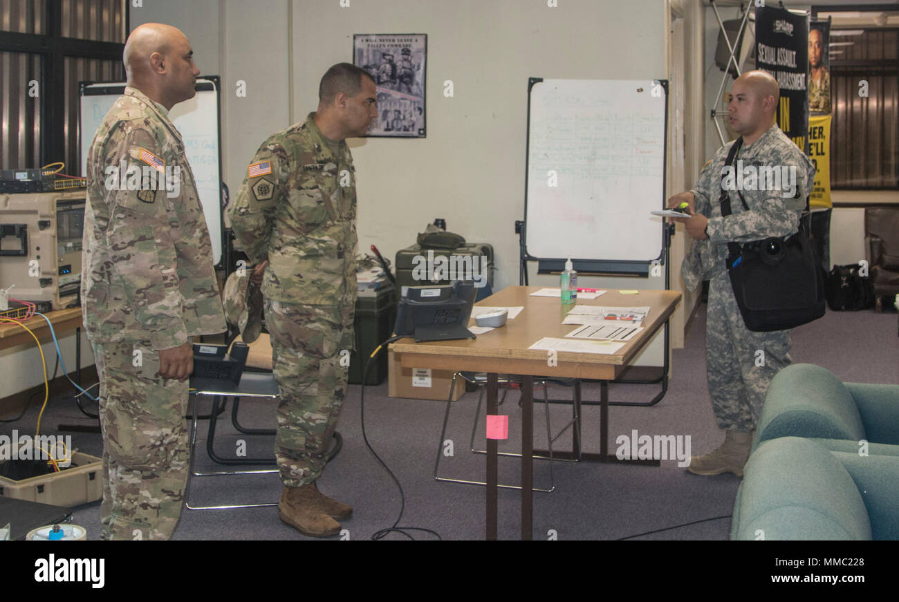 Staff Sgt. Miguel John, listens to 1st Sgt. Memo Santiago, the first ...