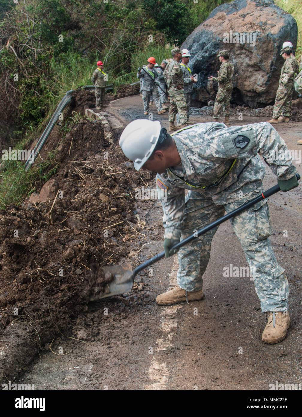 U.S. Army Reserve Spc. Eduardo Hernandez, shovels dirt off a local road ...