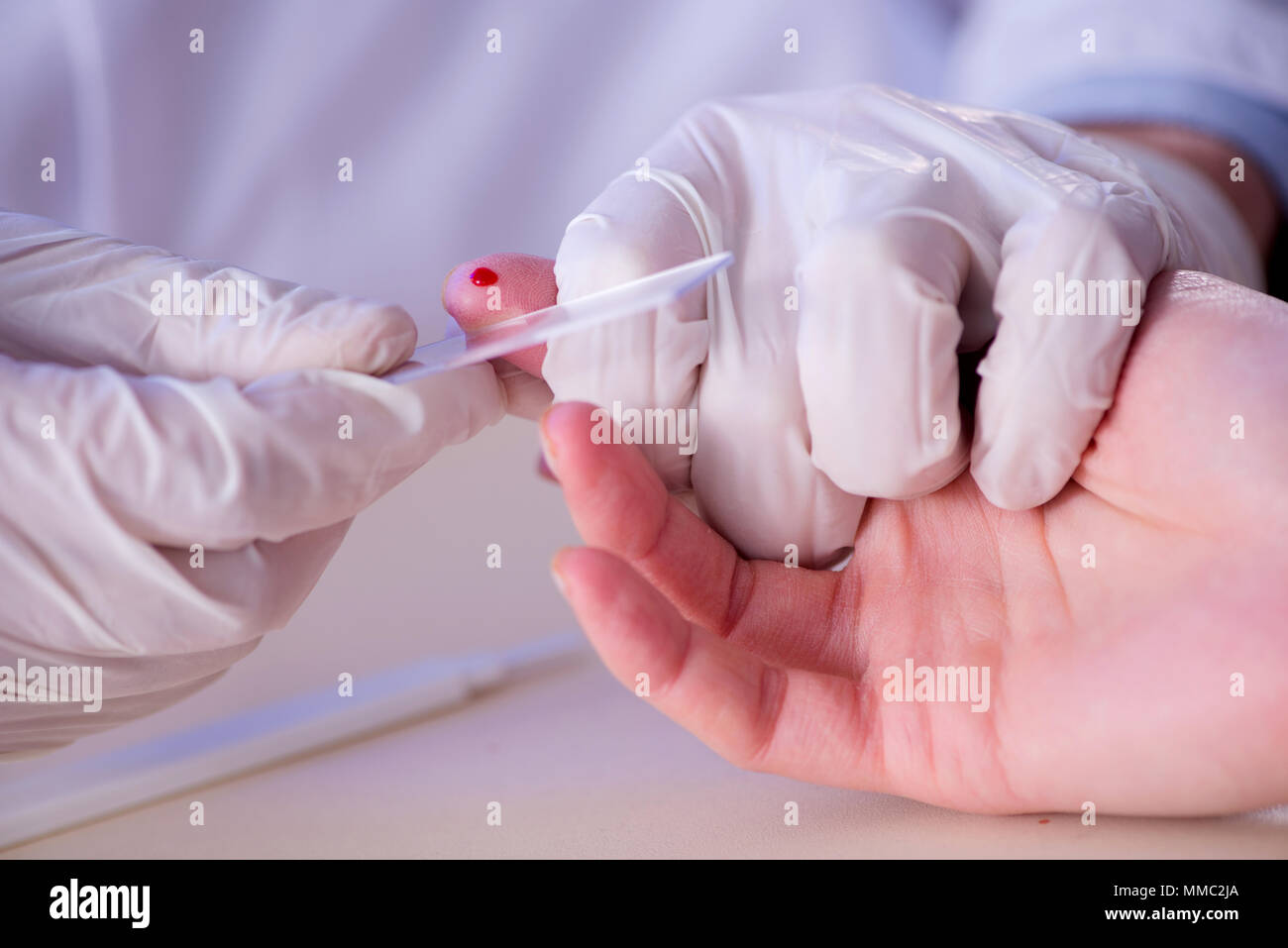 Doctor taking blood samples from finger Stock Photo - Alamy
