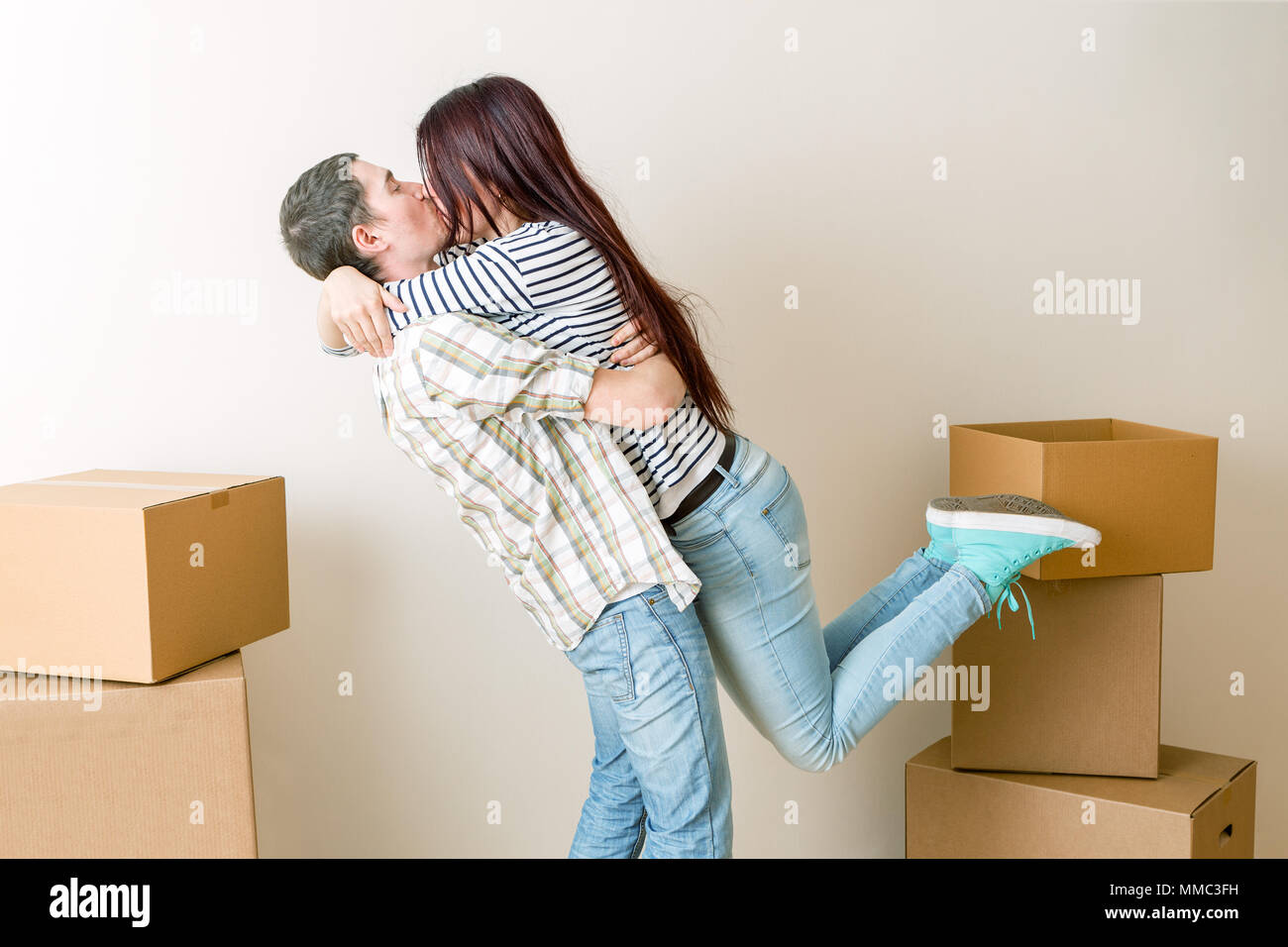 Photo of hugging men and women among cardboard boxes Stock Photo - Alamy
