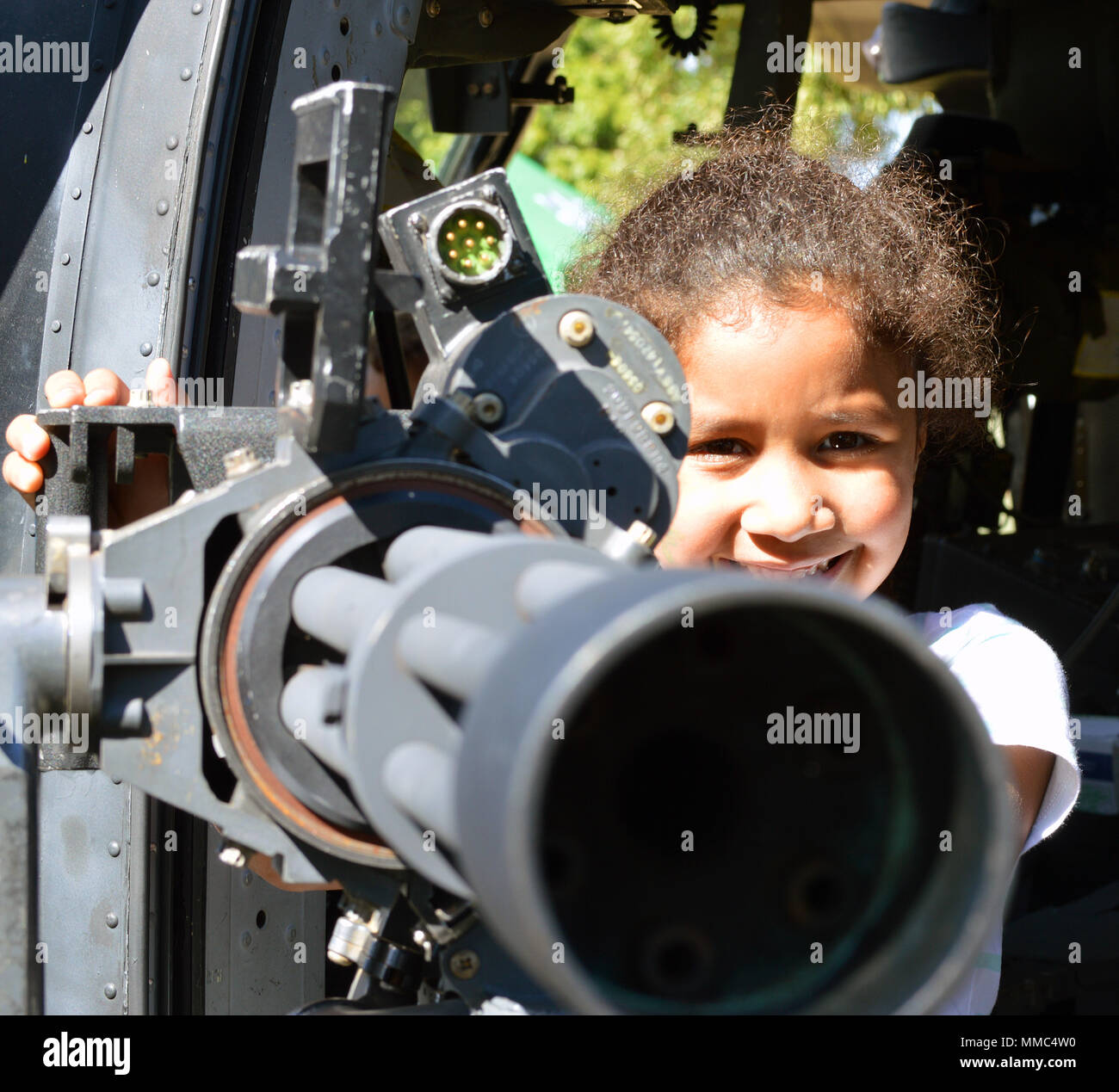 A young girl interacts with an M134 Minigun on a UH-60 Blackhawk Oct. 7 ...