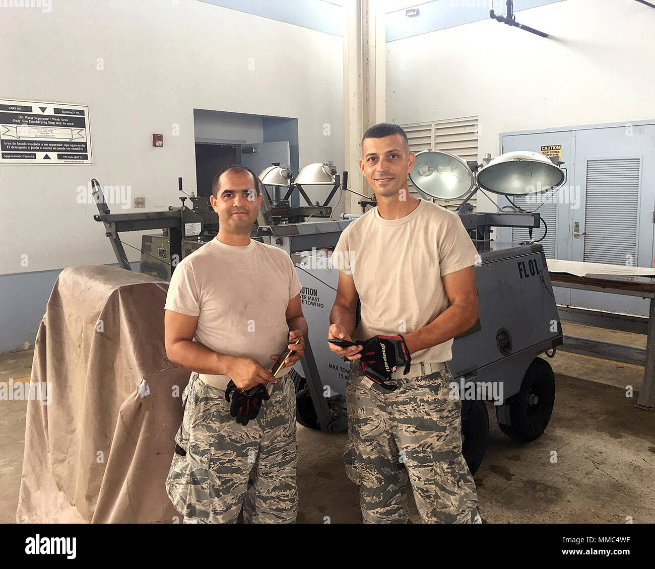 Senior Airman Melvin Cruz and Staff Sgt. Edgardo Gonzalez pause after ...