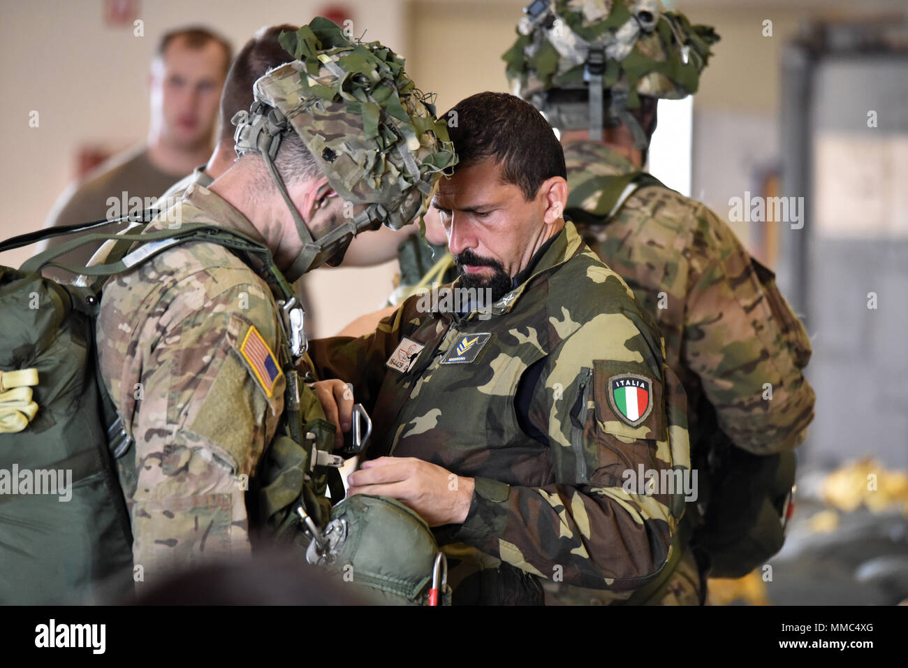 An Italian Army Paratrooper assigned to Folgore Brigade, checks ...