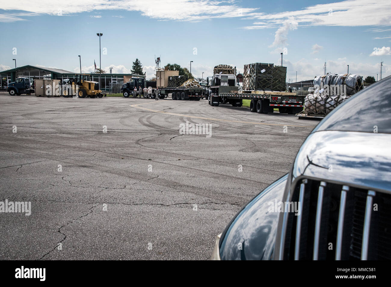 A convoy of tractor trailers transport a Disaster Relief Bedgown System ...