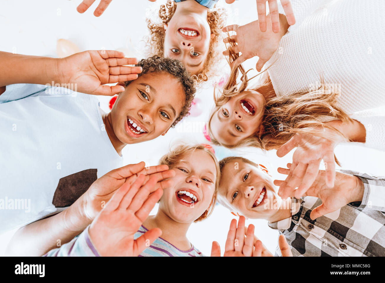 Group of happy children waving at the camera Stock Photo - Alamy