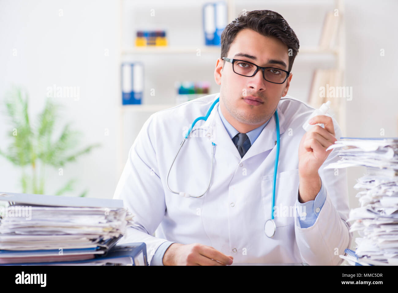 Busy doctor with too much work in hospital Stock Photo - Alamy