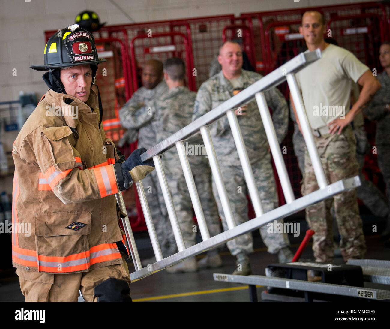 A base leadership competitor carries a ladder during the eighth annual ...