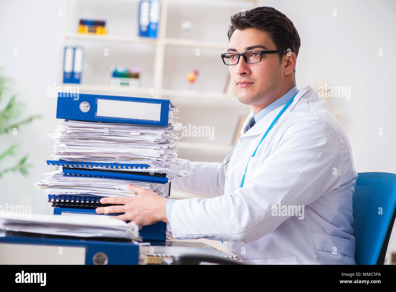 Busy doctor with too much work in hospital Stock Photo - Alamy