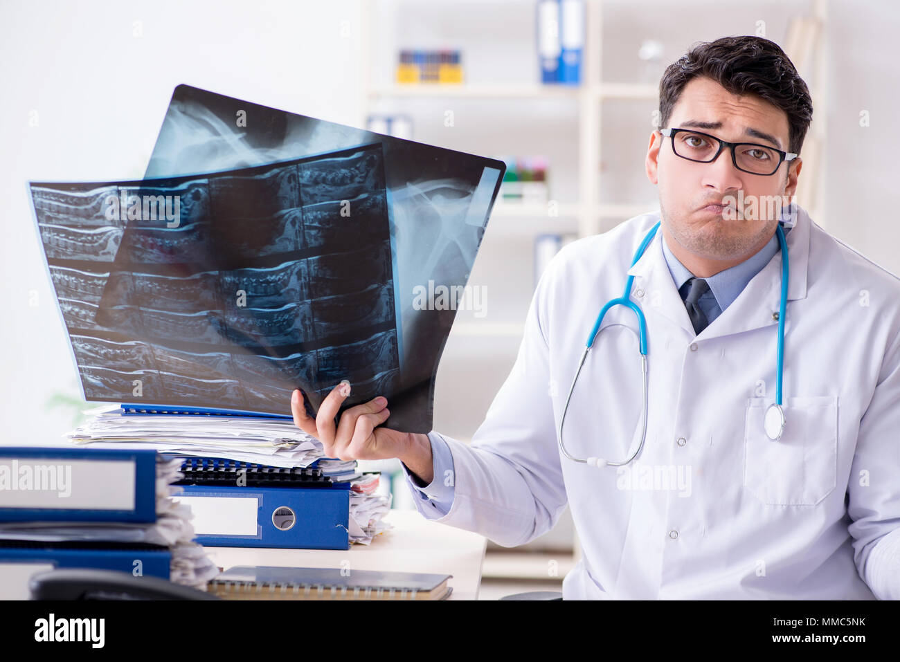 Tired radiologist with x-ray image in hospital Stock Photo - Alamy