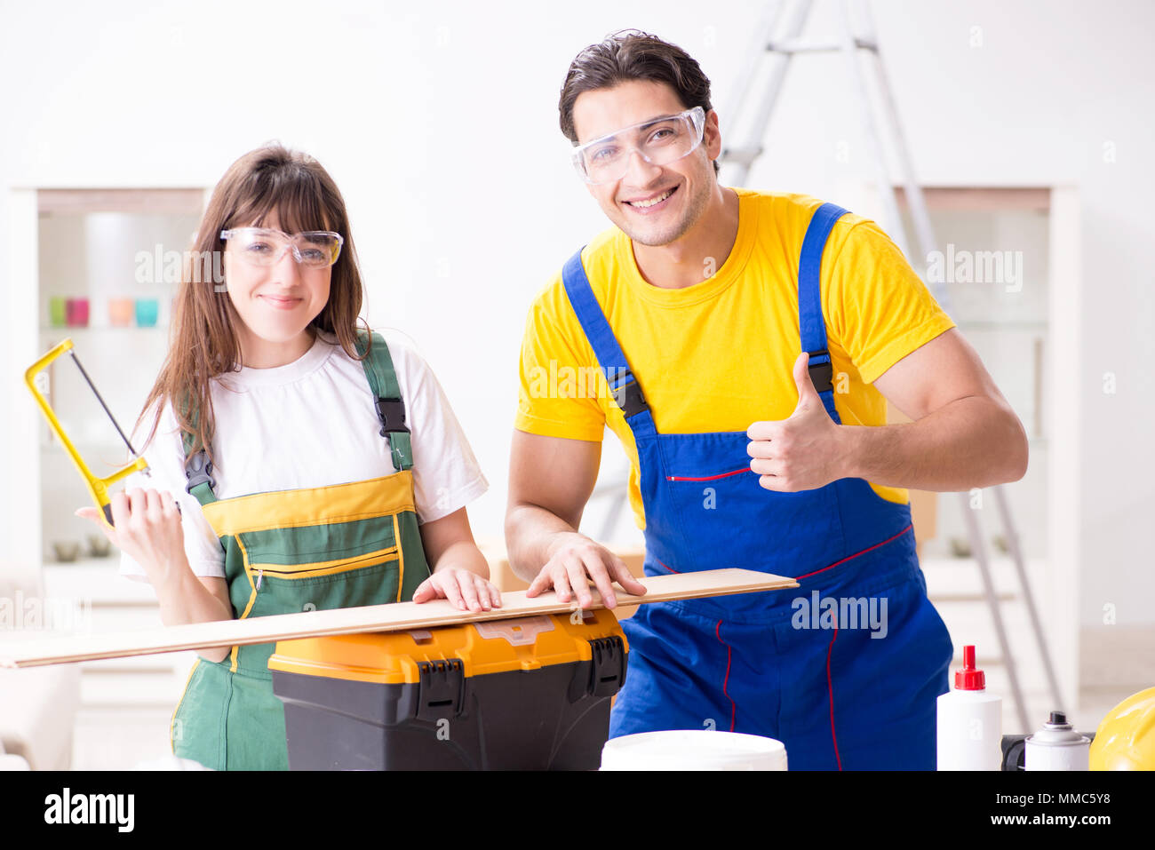 Man explaining woman woodworking tips in wood workshop Stock Photo - Alamy