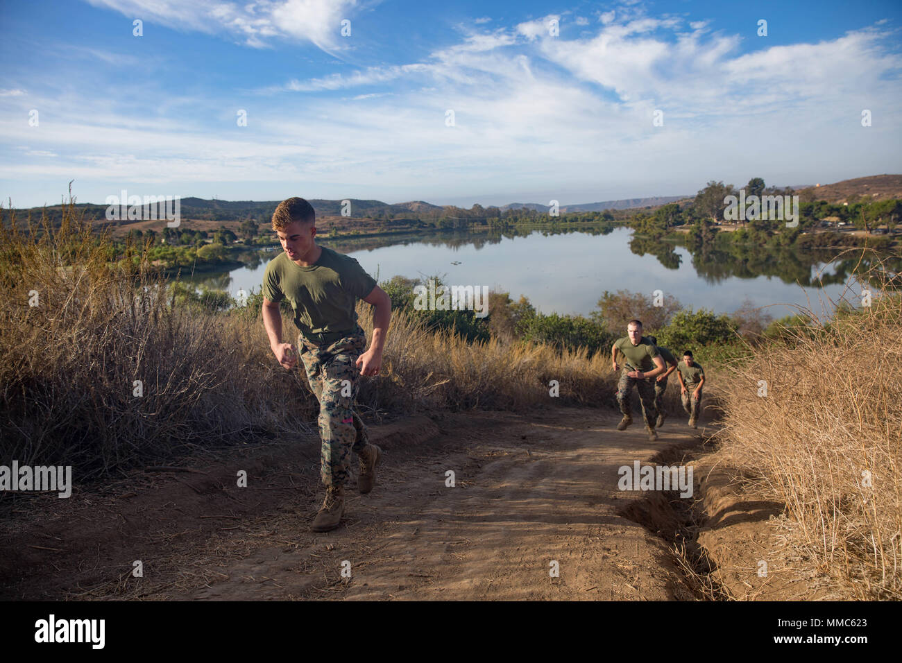 U.S. Marines run up a hill during the Outdoor Obstacle Course Challenge ...